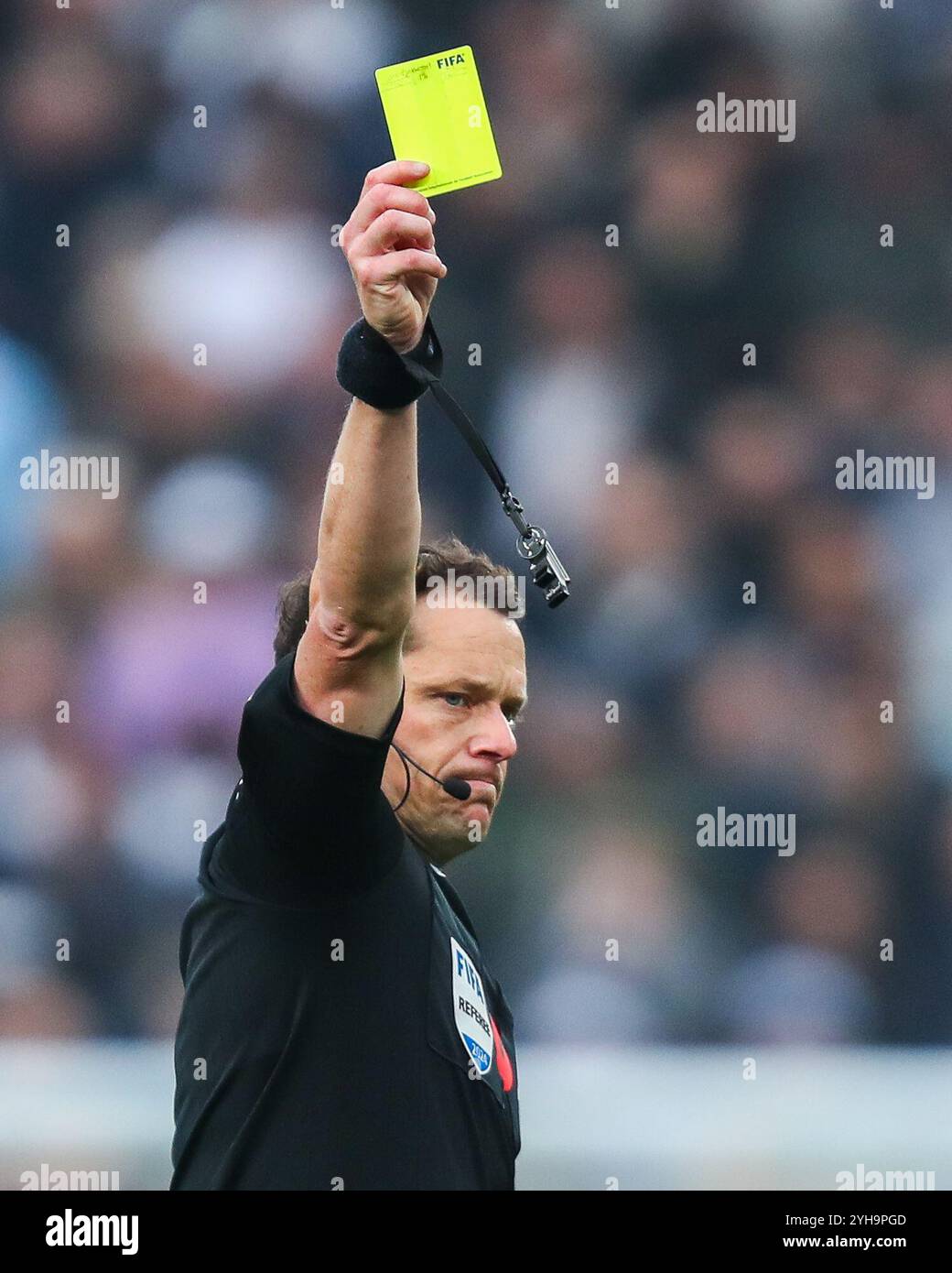 Referee Darren England shows a yellow card during the Premier League ...
