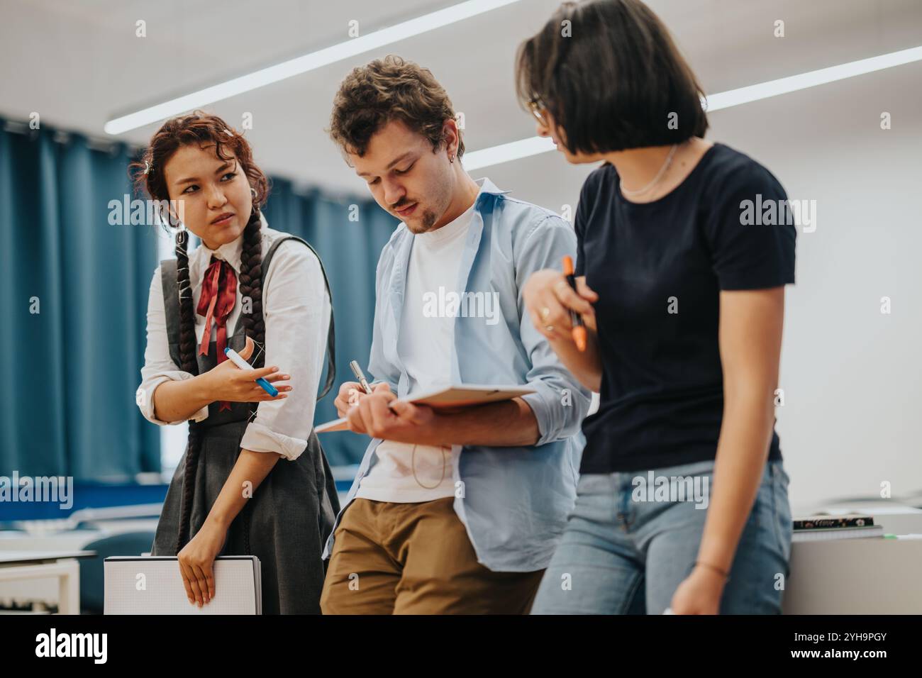 College students exchanging notes hi-res stock photography and images ...
