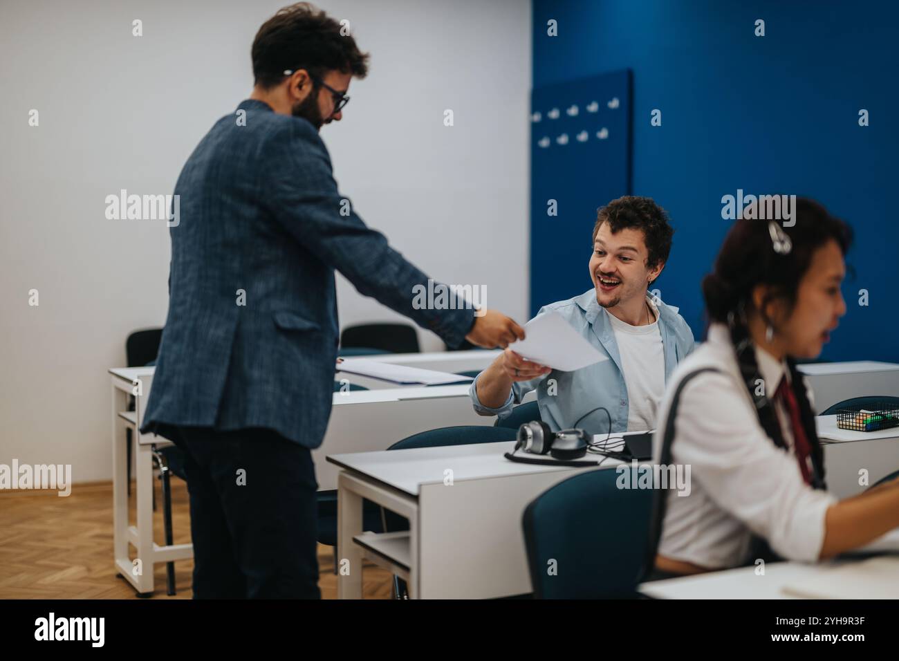 Handing books classroom hi-res stock photography and images - Alamy