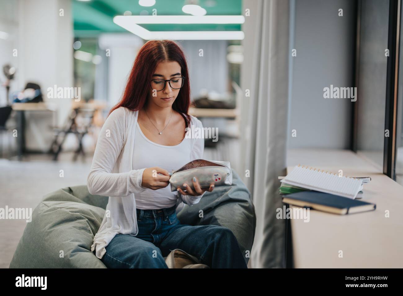 High school student studying in a modern library space Stock Photo - Alamy
