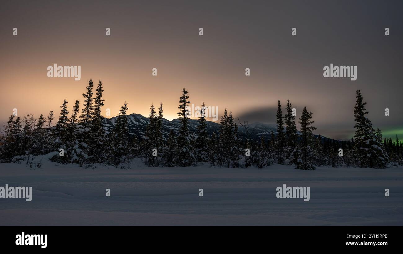 Winter night time landscape in northern Canada with full cloud cover ...