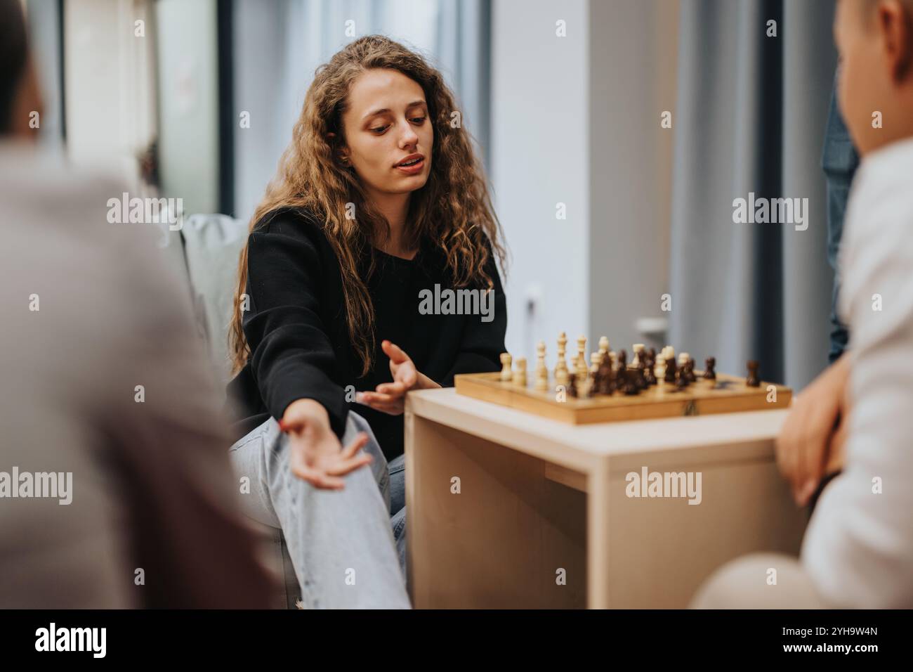 Teenagers engaging in a focused chess game at school Stock Photo - Alamy