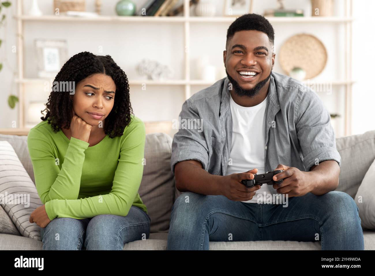 Boring Date. Excited Black Guy Playing Video Games And Ignoring Girlfriend Next To Him Stock ...