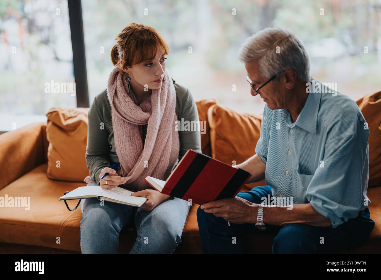 Senior professor mentoring female student on study session Stock Photo ...