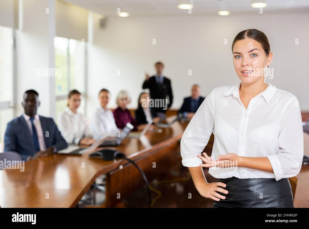 Millennial white businesswoman posing with inviting hand gesture Stock ...