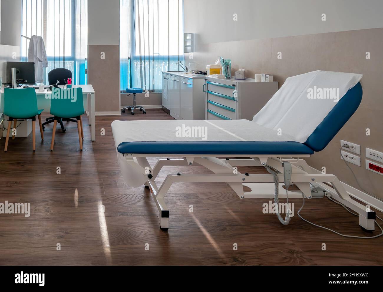 Medical office interior with examination table and doctor's workplace ...