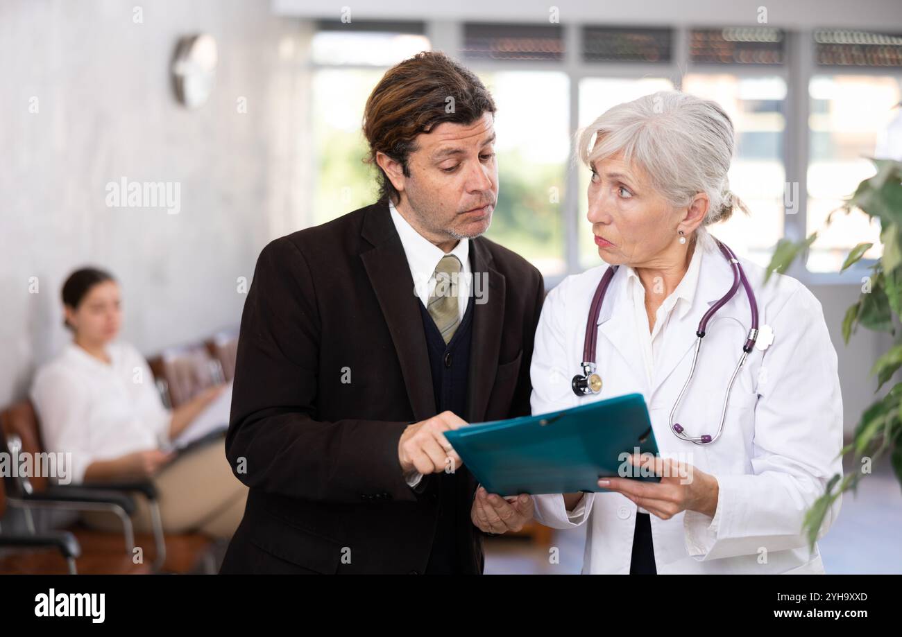Man consults with a doctor about the diagnosis and treatment of disease ...