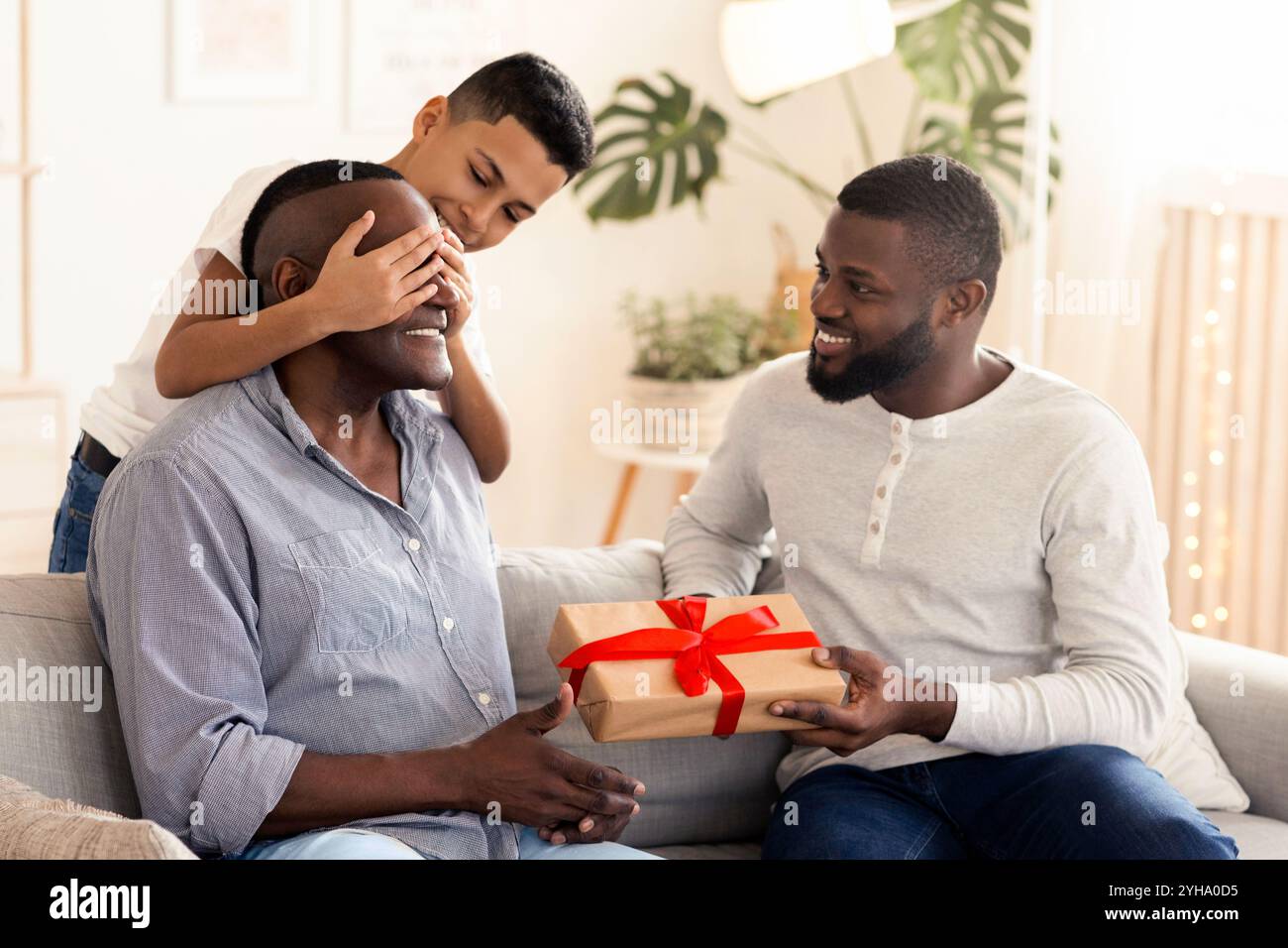 Affectionate Little Boy And His Father Surprising Happy Granddad With ...