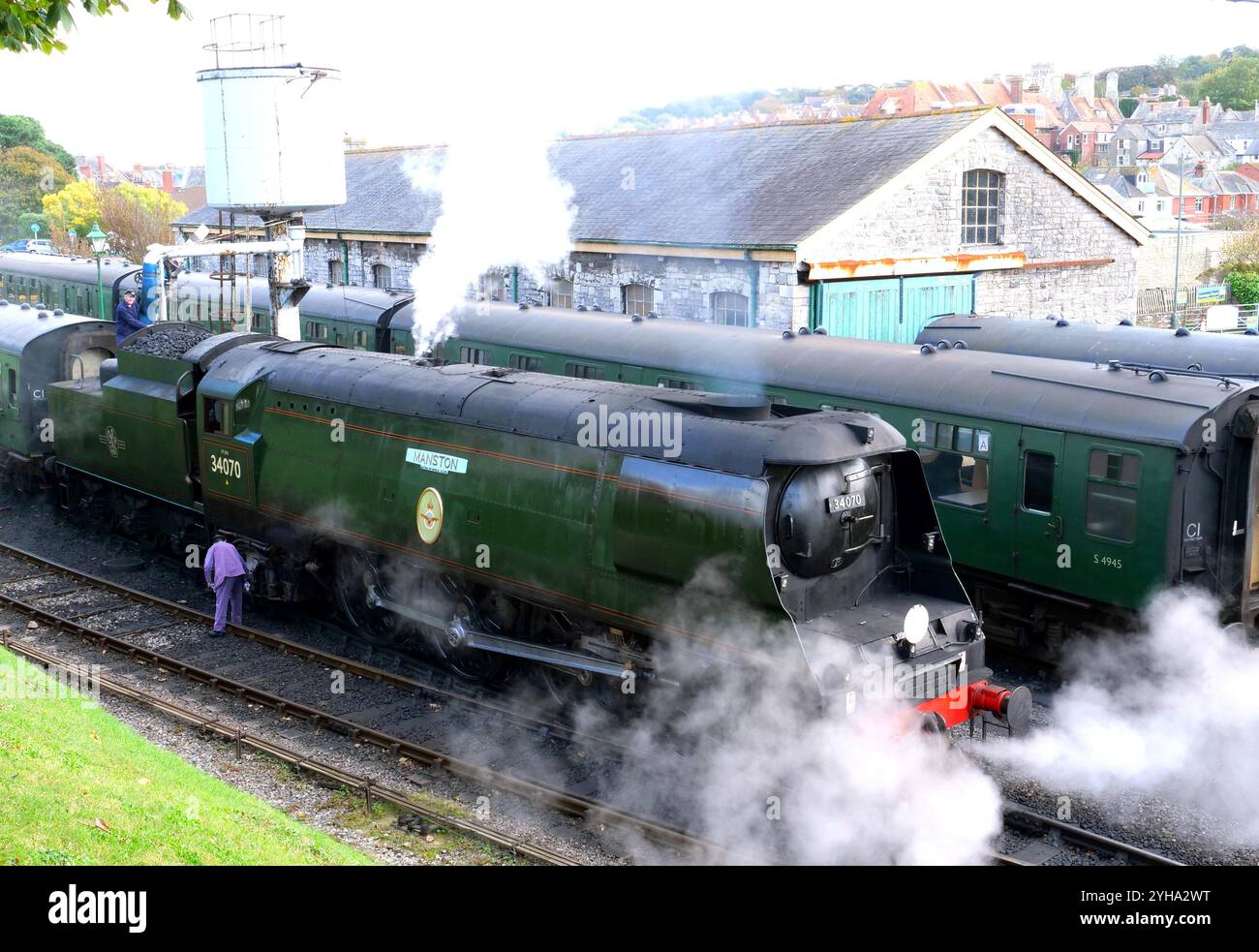 A sideways view of the steam locomotive 'Manston' receiving maintenance ...