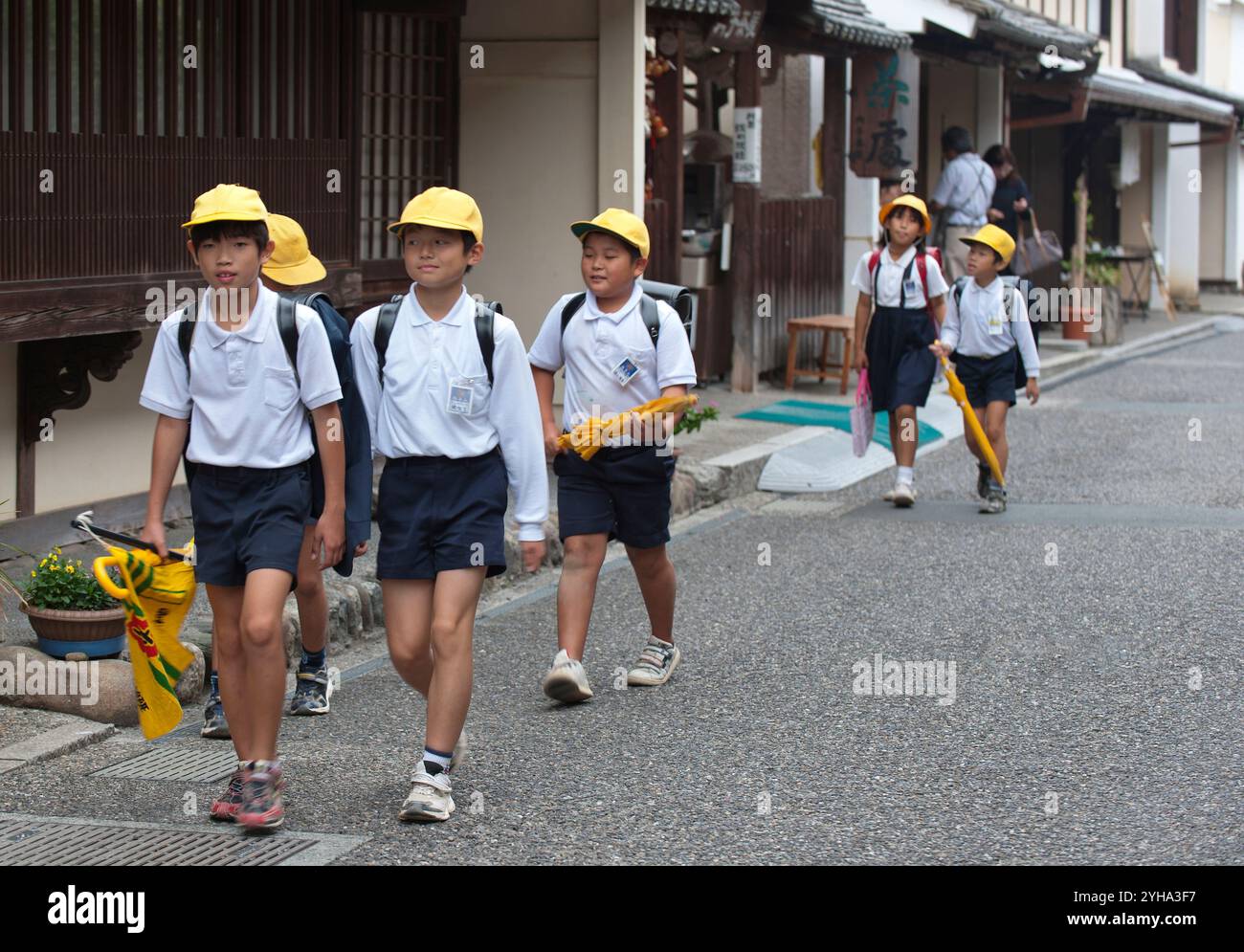 Group of elementary school children in matching uniforms and caps ...