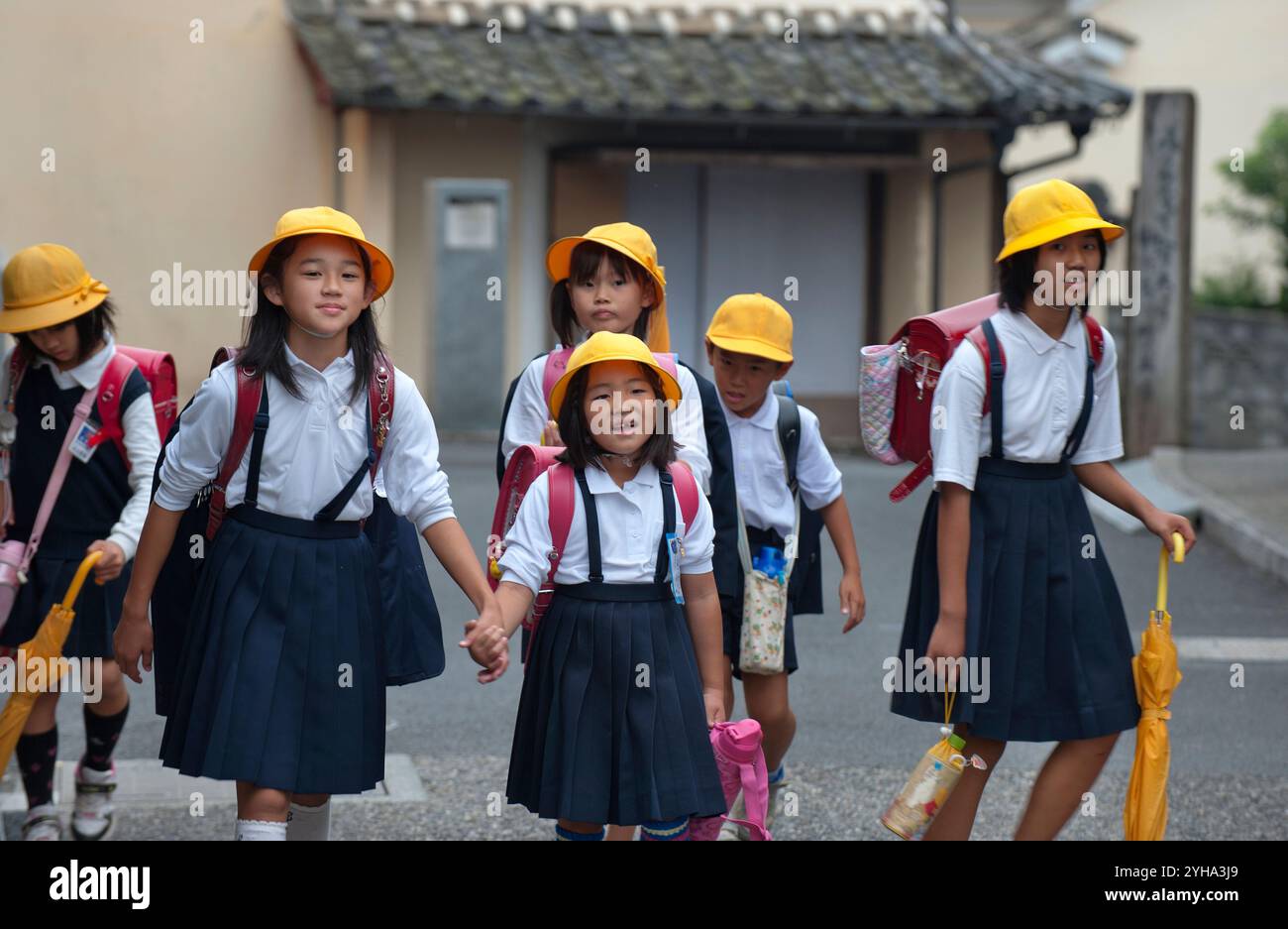 Group of elementary school children in matching uniforms and caps ...