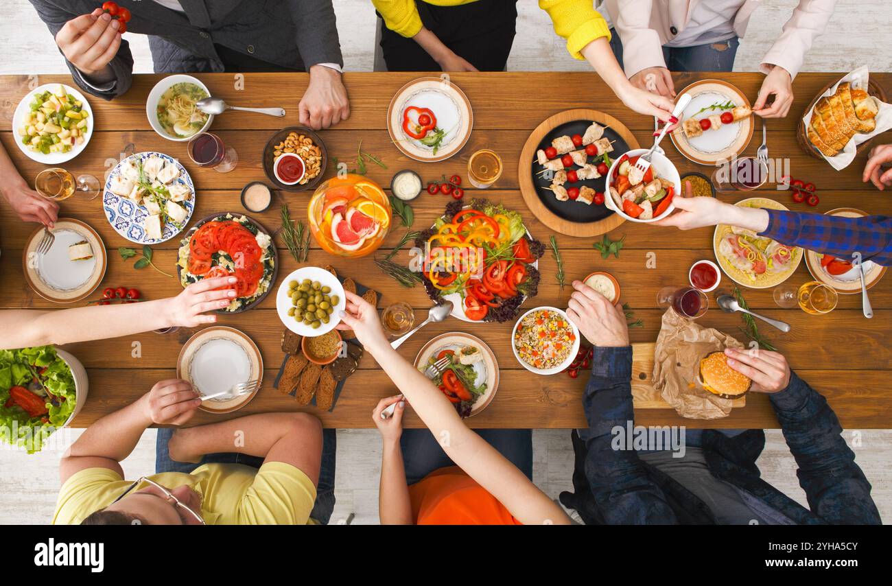 People eat healthy meals at served table dinner party Stock Photo - Alamy