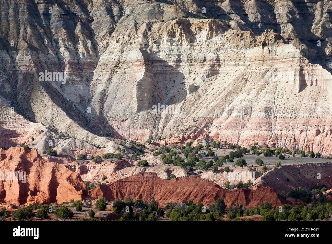 Sharp eroded ridges casting shadows over the sandstone buttes ...