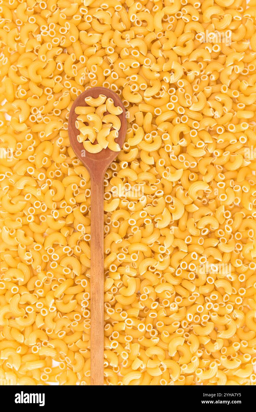 Uncooked Chifferi Rigati Pasta Background with Wooden Spoon. Fat and ...