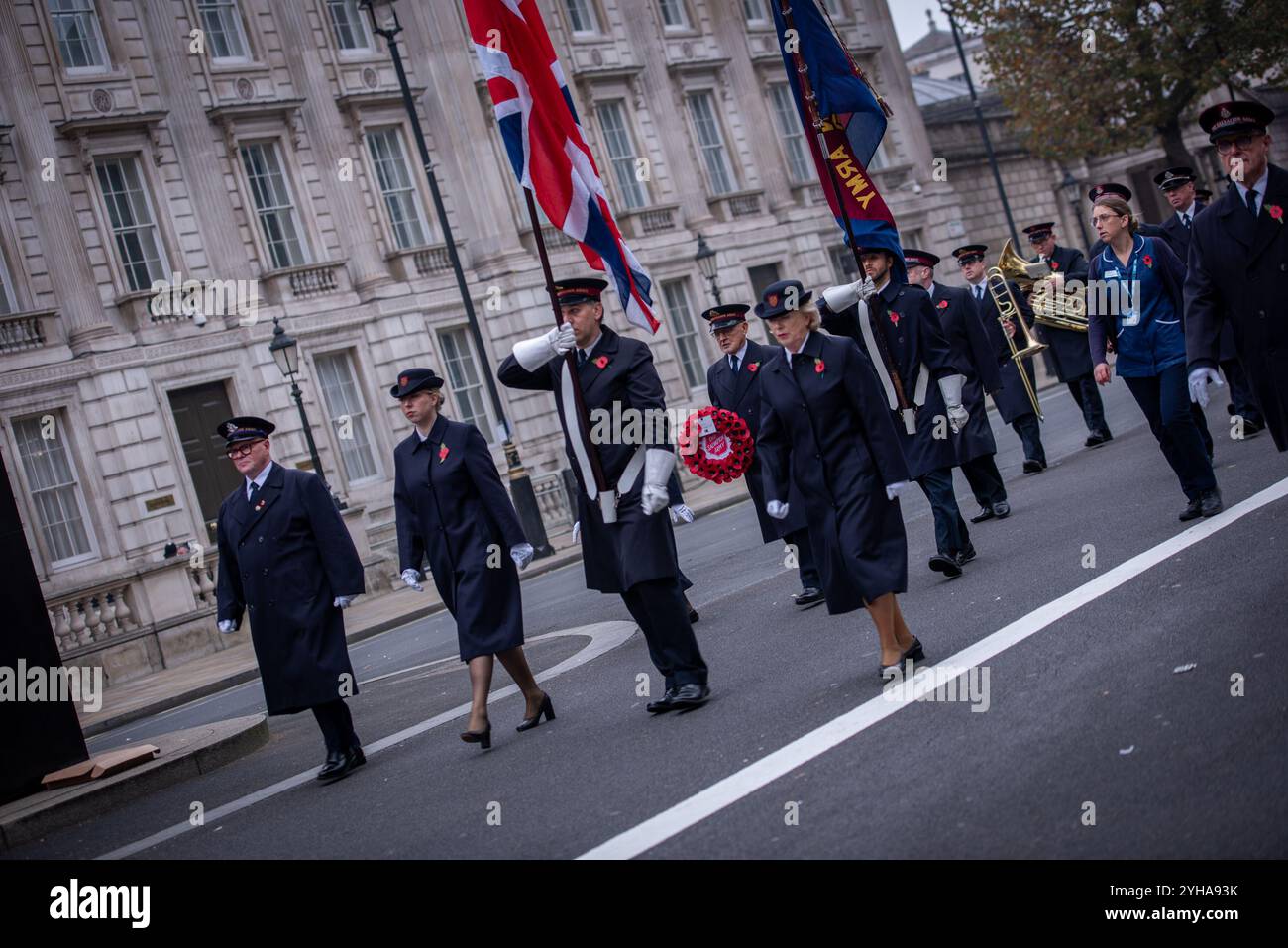 The military and civilian servicemen and women march past The Women of World War II memorial ...