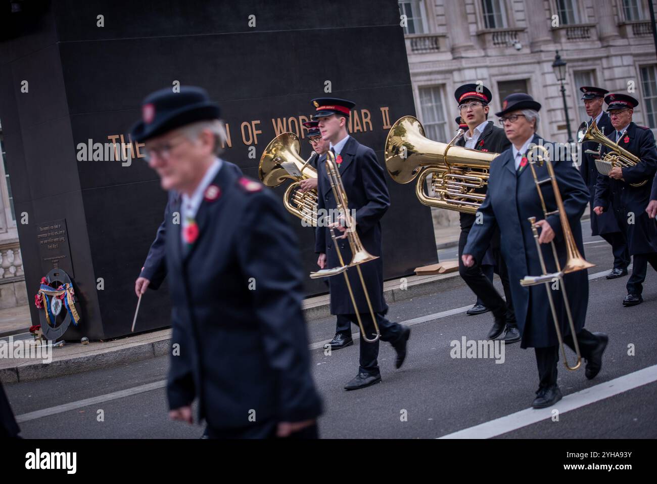 A marching band parade past The Women of World War II Memorial Cenotaph ...