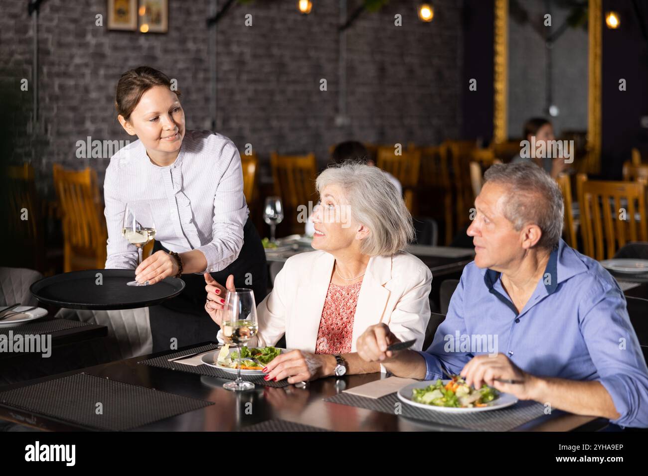 Smiling waitress positive family hi-res stock photography and images ...