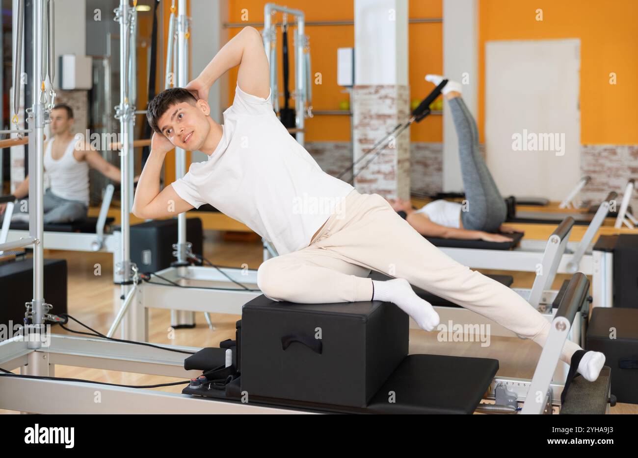 Man in different poses performs static and dynamic exercises on ...