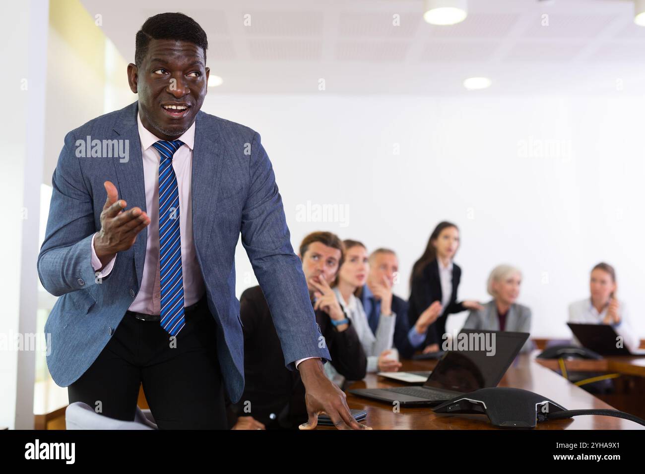 Businessman arguing during conference Stock Photo - Alamy