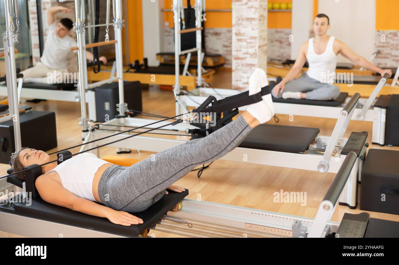 Woman legs on reformer hi-res stock photography and images - Alamy