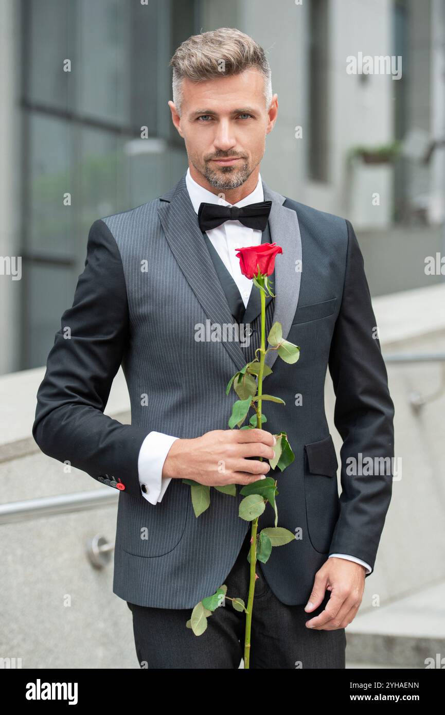 elegant man in black tux. man wearing tux bowtie outdoor. luxury tux ...