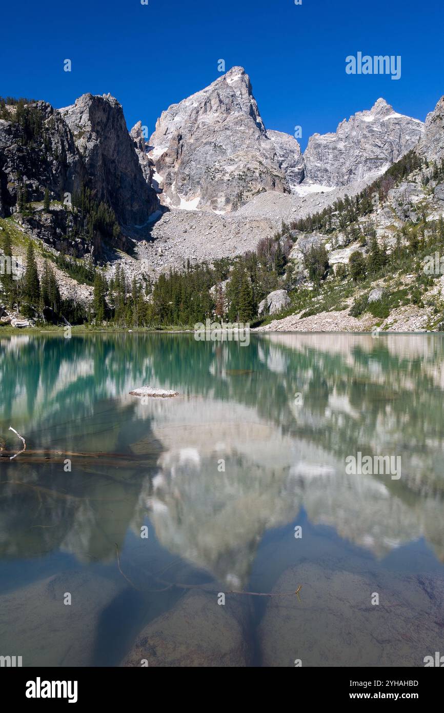 Delta Lake reflects The Grand Teton and surrounding peaks in the Teton ...