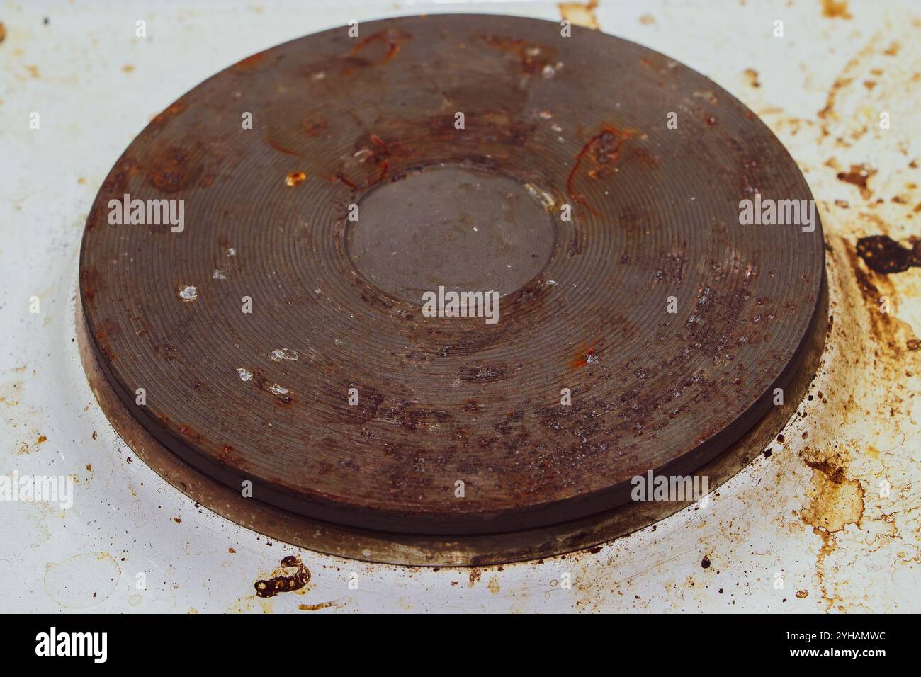 Dirt and grease on the white electric stove. Dirty kitchen after ...