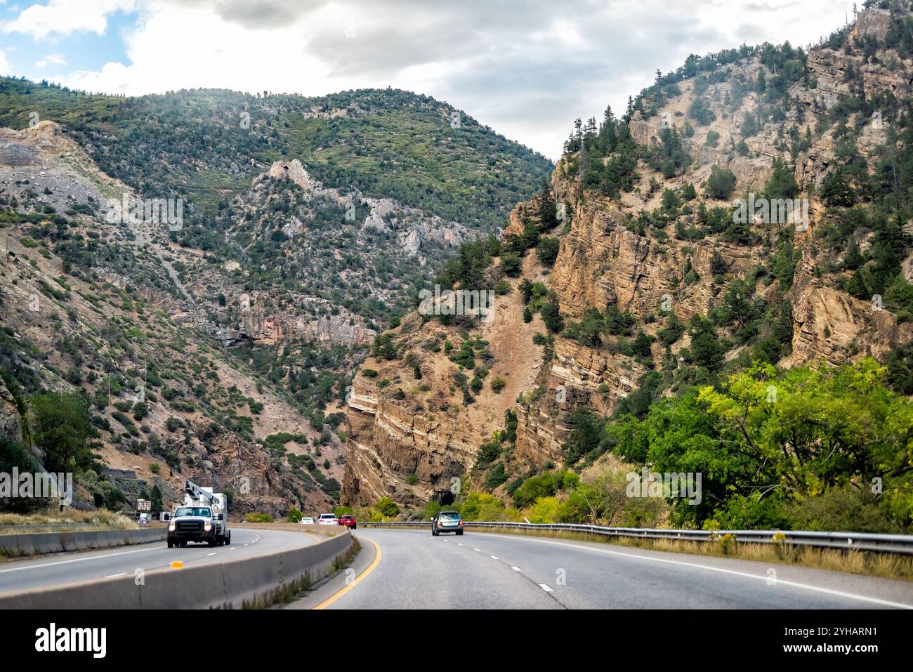 Glenwood Springs, Colorado interstate highway 70 road with cars driving by ski resort town in ...