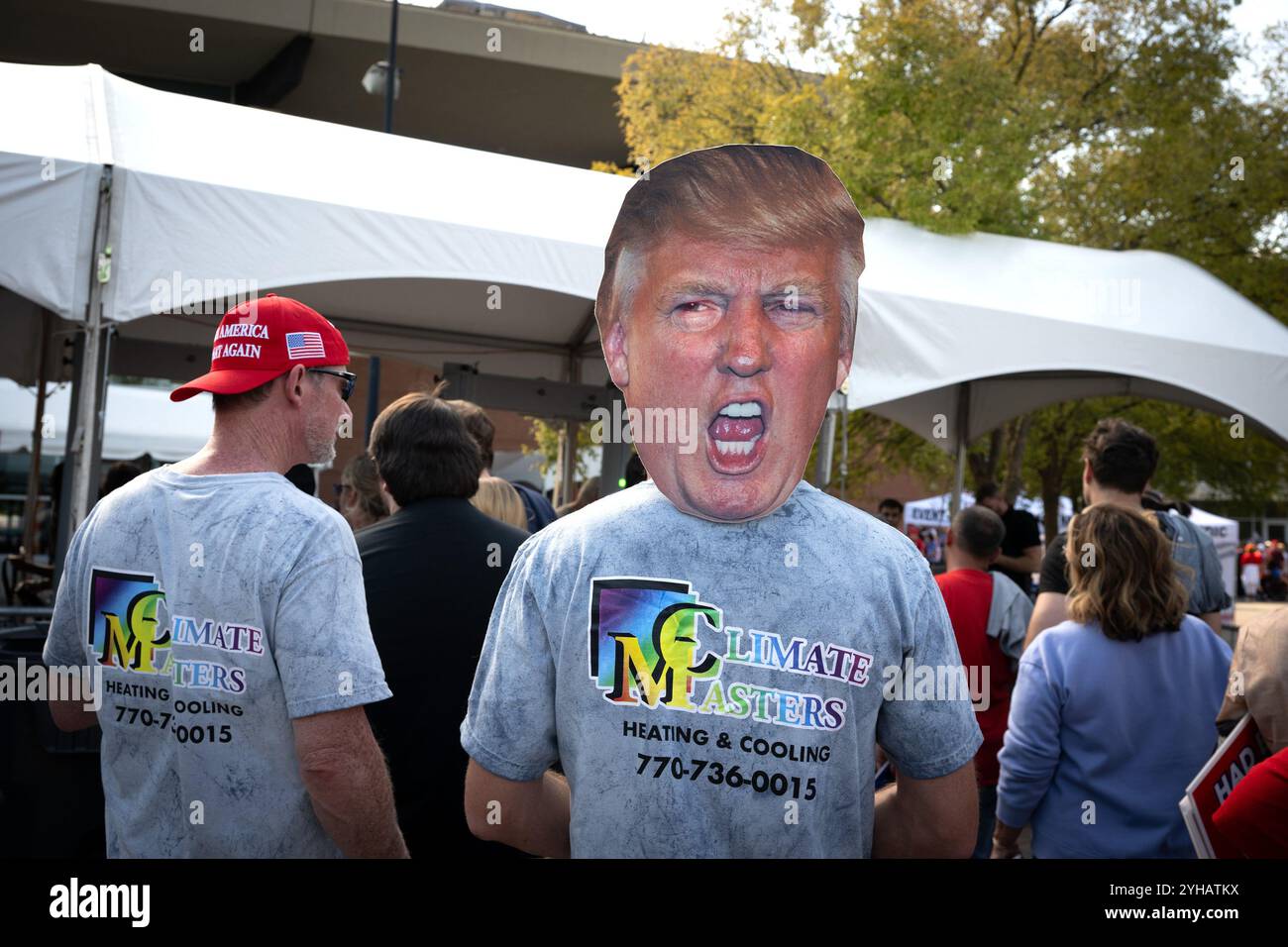 Duluth, Georgia, USA. 23rd Oct, 2024. A Trump supporter wears a larger ...