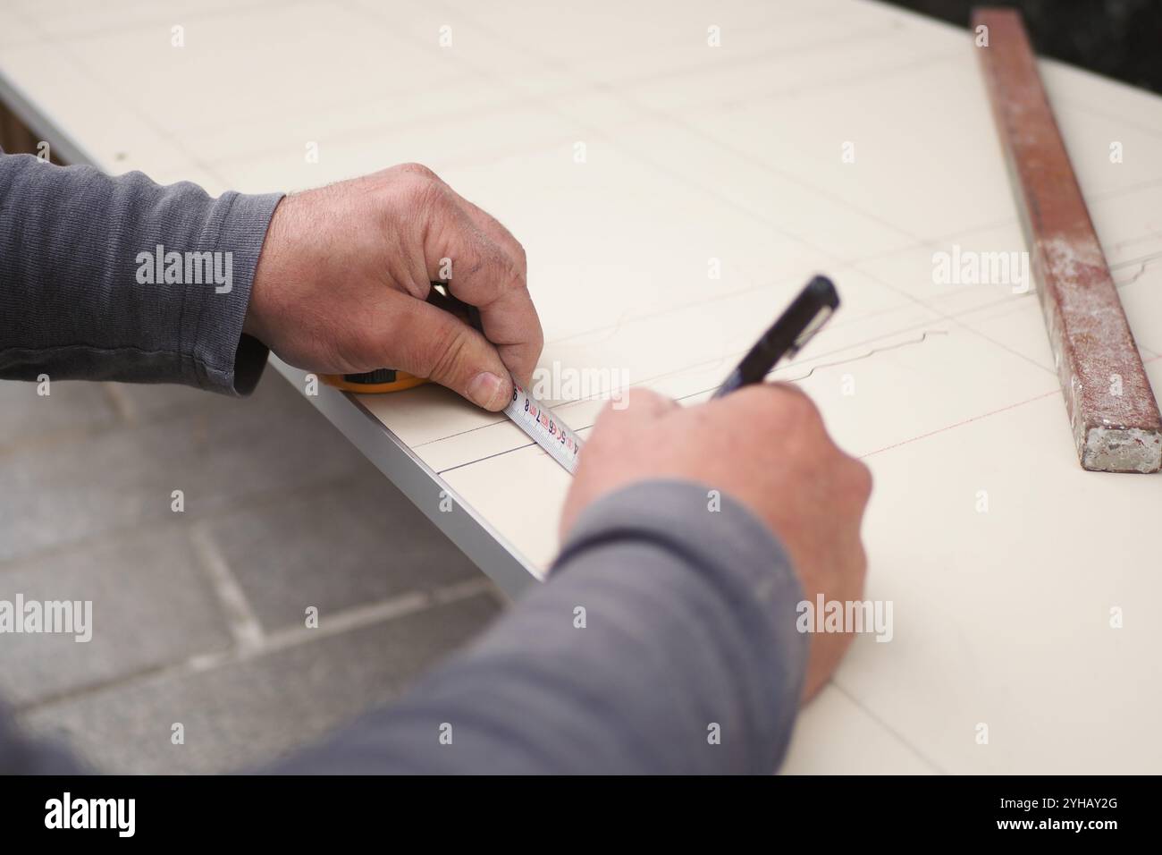 The precise methodology involved in measuring and marking tiles for ...