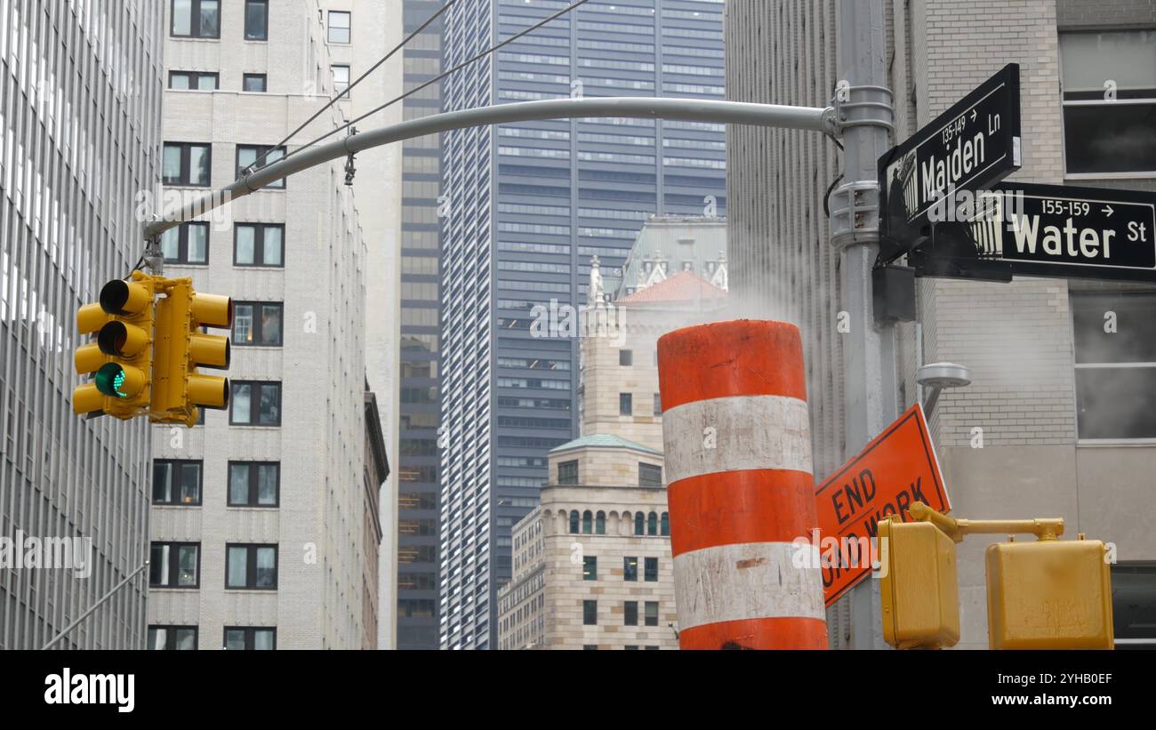 Steam vapor vented on New York City Water street, orange vapour tube ...