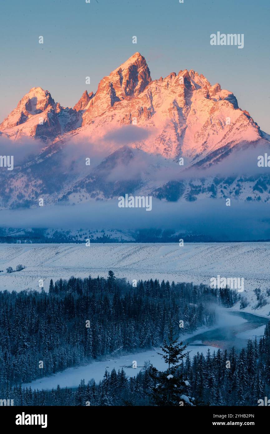 The Teton Mountains loom above the Snake River on an early winter day ...