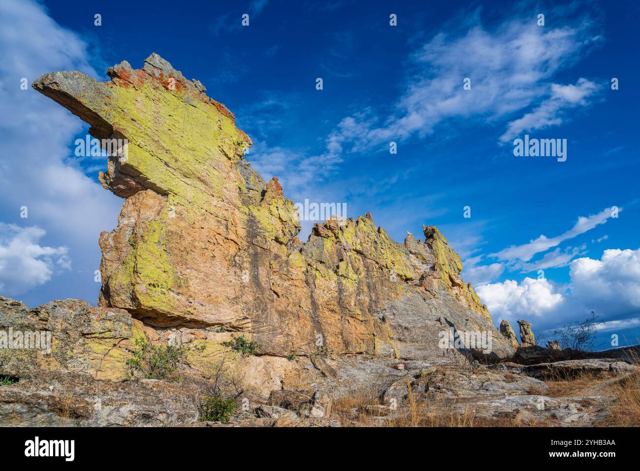 Weathered sandstone cliff with monster-like silhouette, covered in ...