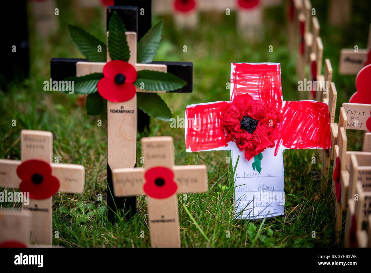 London, UK. 10th Nov, 2024. A memorial with poppies, small crosses and a hand coloured cross are ...