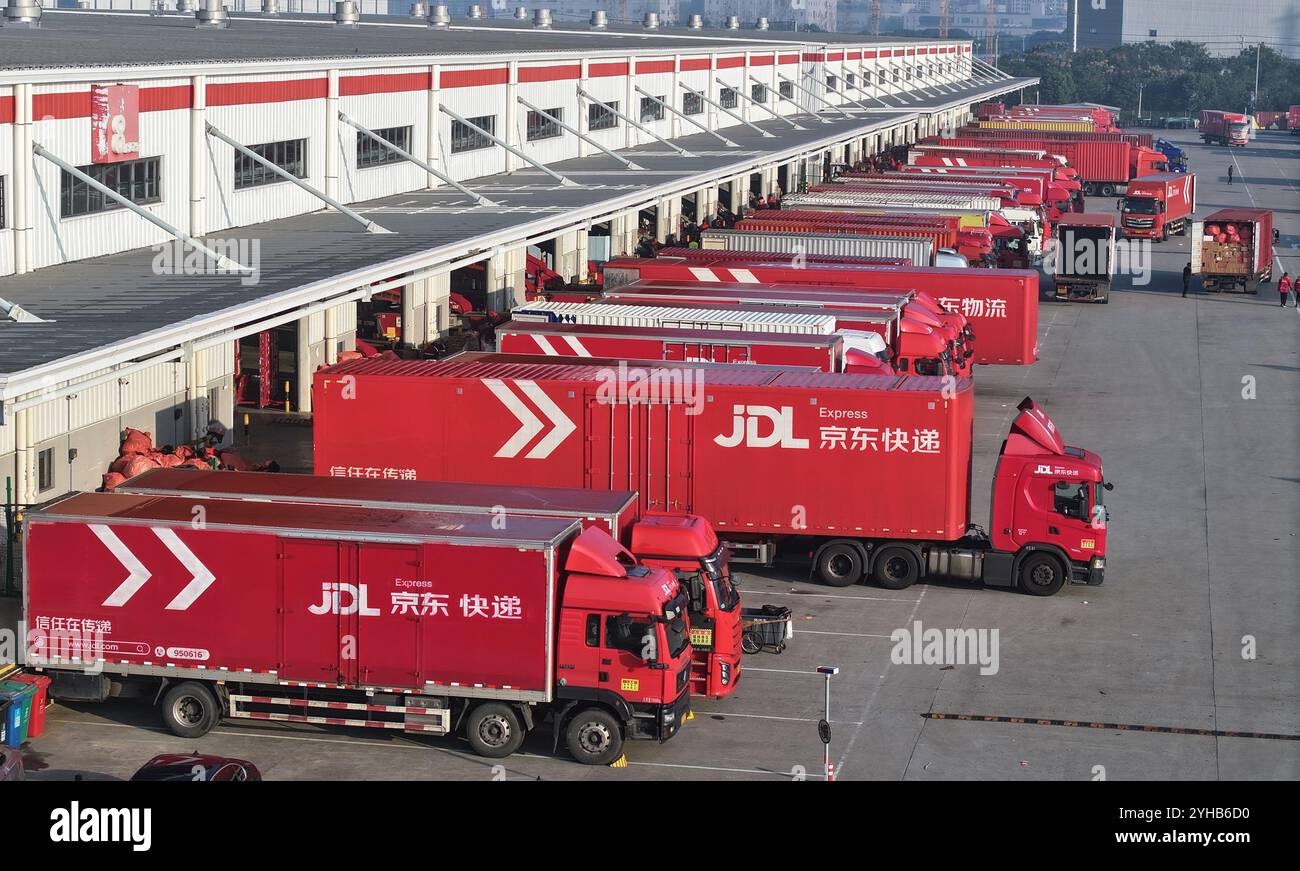 KUNSHAN, CHINA - NOVEMBER 11, 2024 - Multiple express logistics trucks load and unload goods at ...