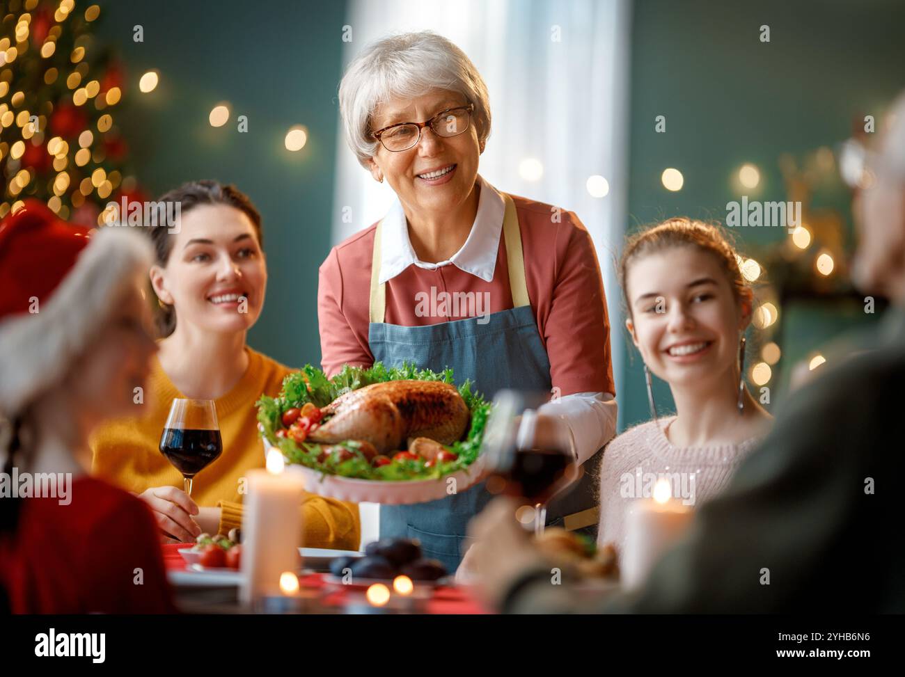 Merry Christmas. Happy family are having dinner at home. Celebration holiday and togetherness ...