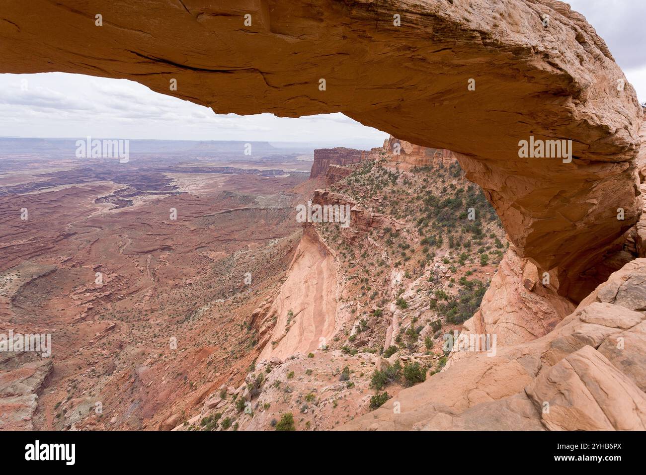 Mesa Arch swooping over the vast canyons networking the landscape below ...