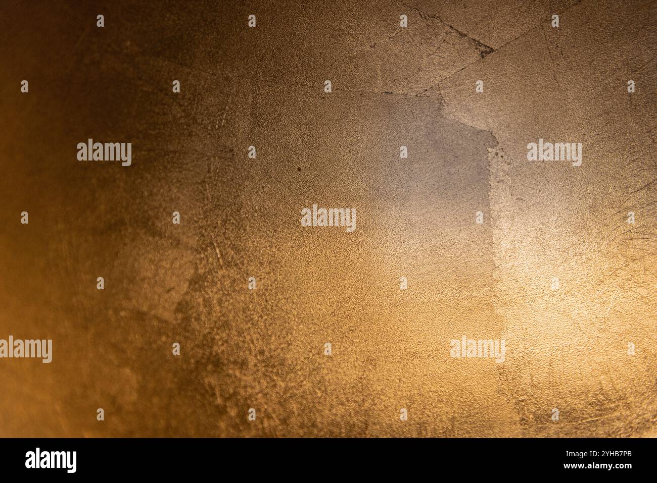 Rustic golden brass colored textured metal material with shawdow and ...