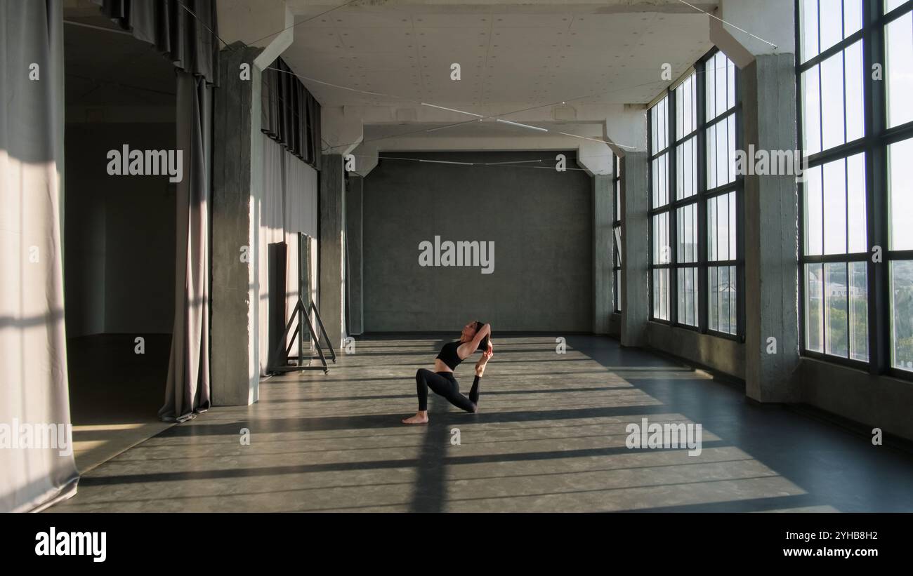 Gymnastic pose. Stretch practice. Fit woman in activewear training yoga ...