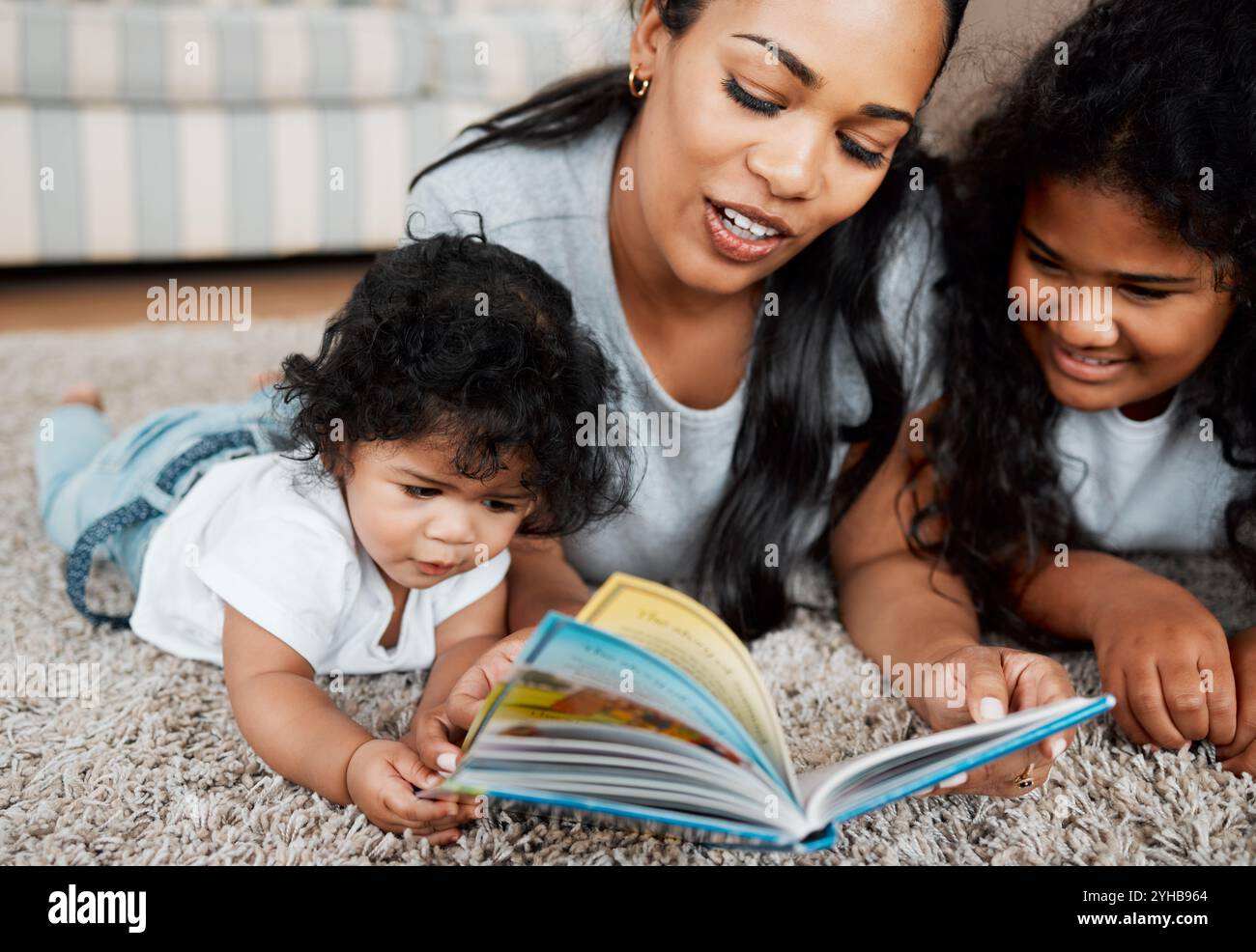 Happy mom, kids and reading with book on floor for story, bonding or ...