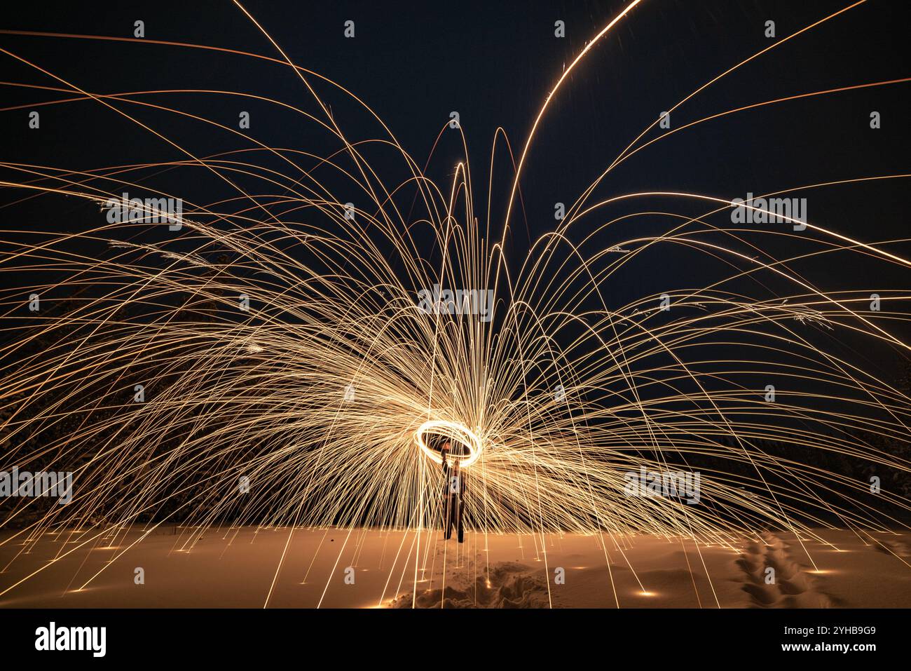 A winter snowy landscape with amazing sparking, steel wool effect ...