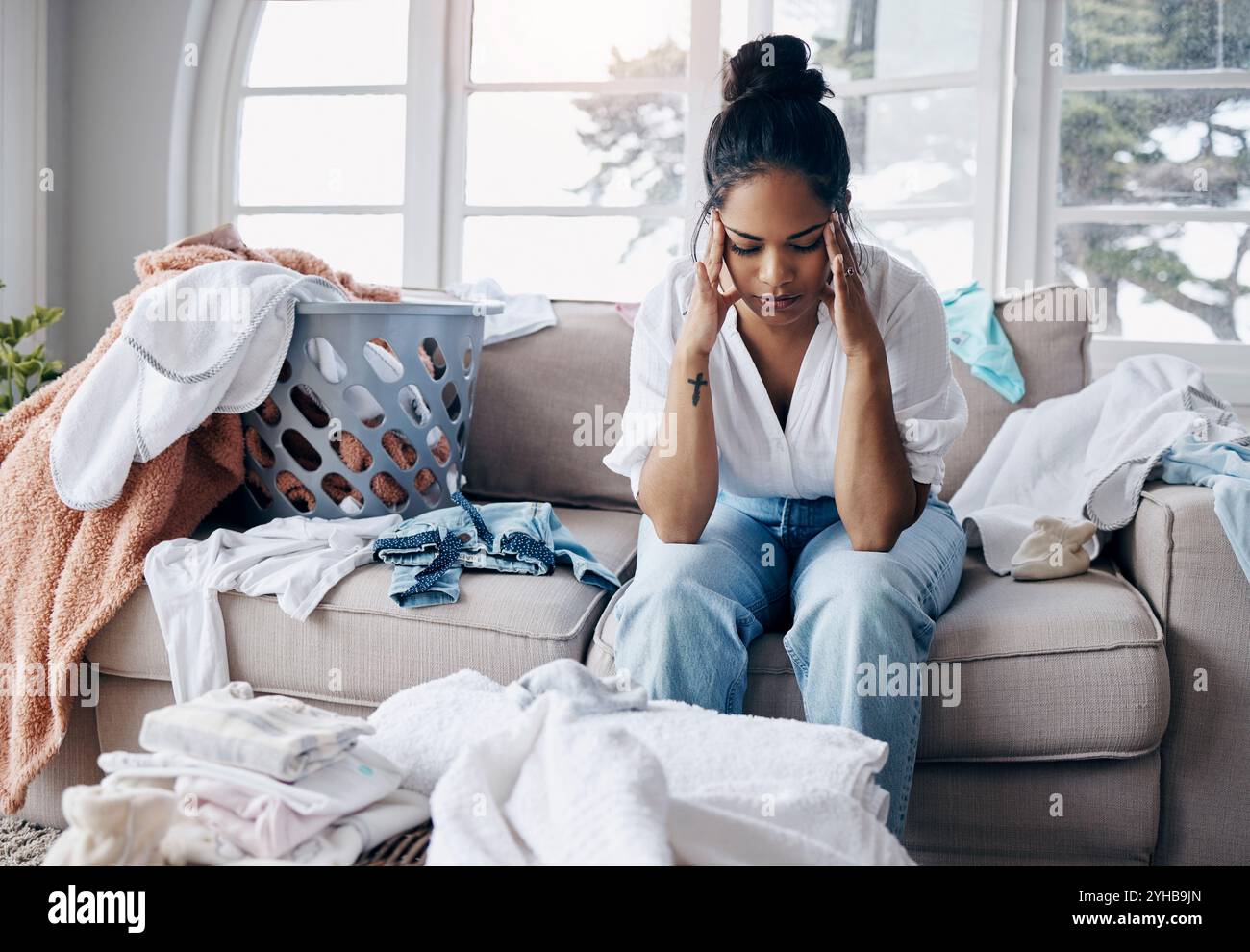 Fatigue, headache and woman on sofa with laundry, housework schedule ...