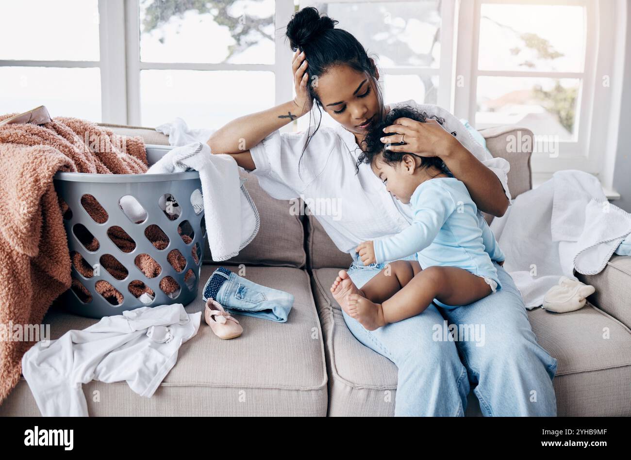 Mother, home and hug baby for comfort, tired woman and laundry basket ...