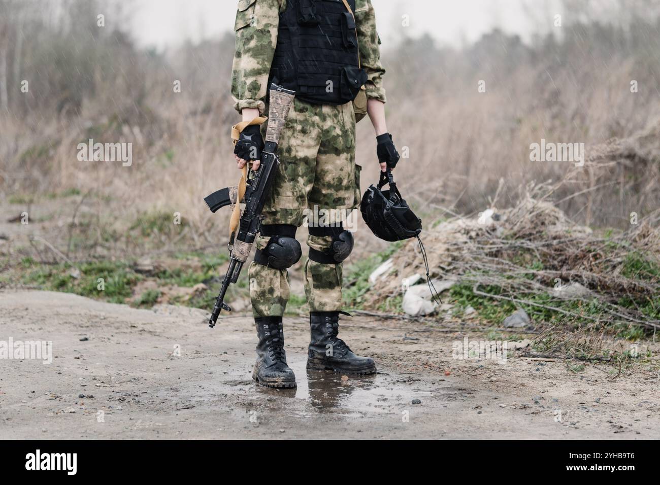 Professional soldiers training with weapon on a military range. A ...