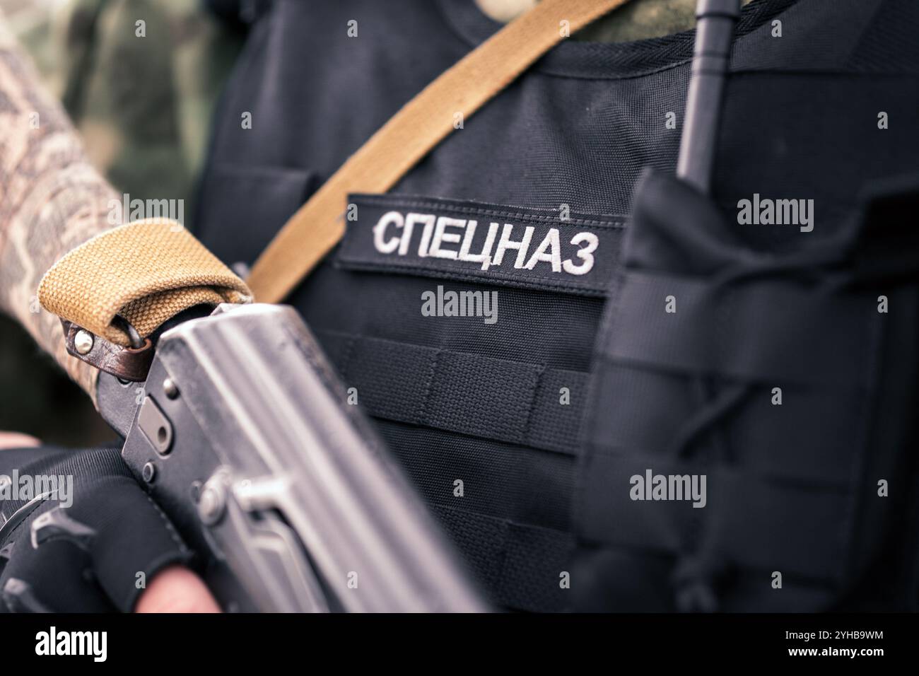 A special forces soldier with a machine gun in close-up. translation of the inscription on the ...