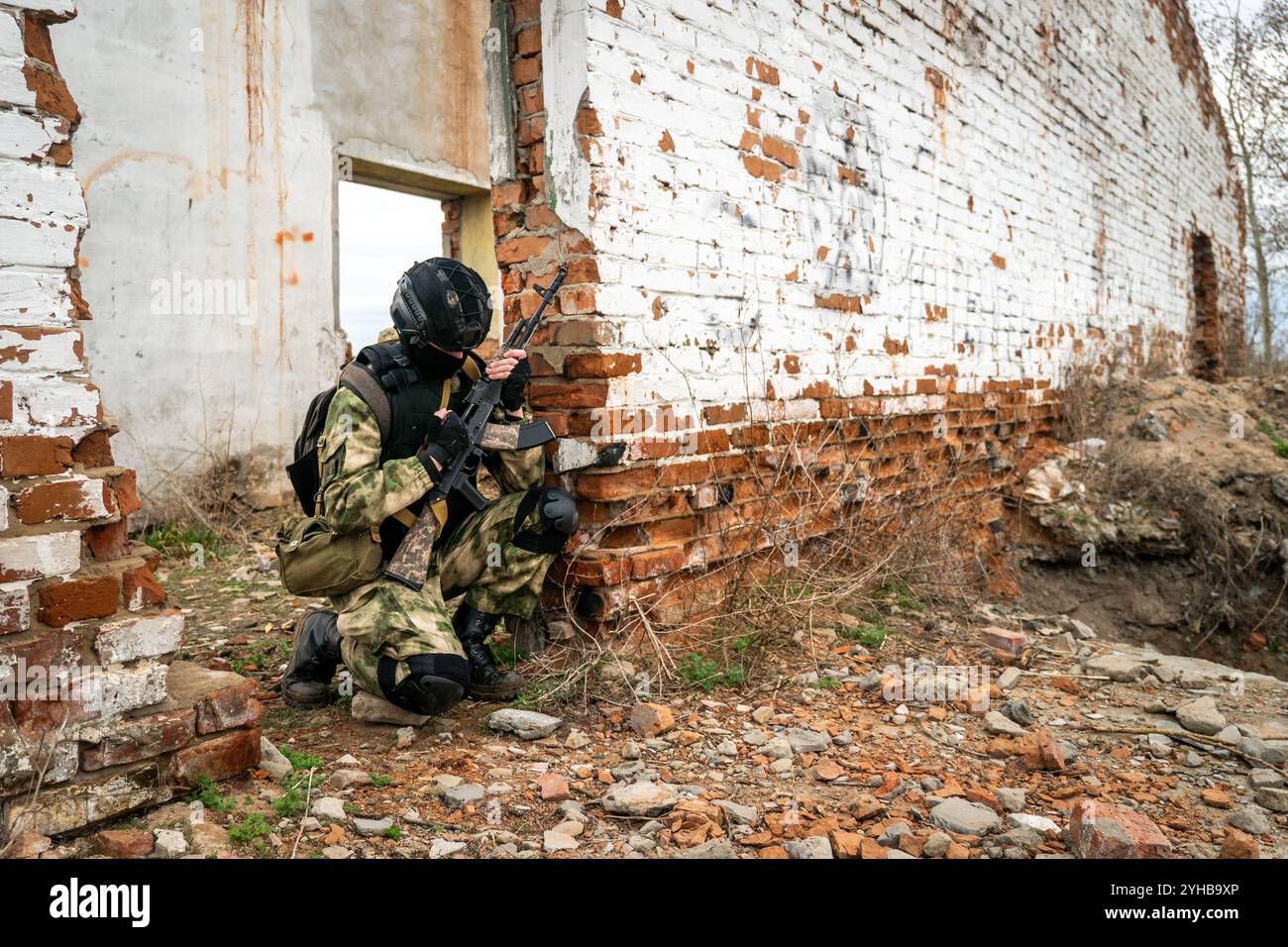 A special forces soldier reloads an assault rifle. Preparing for battle. Military exercises. The ...