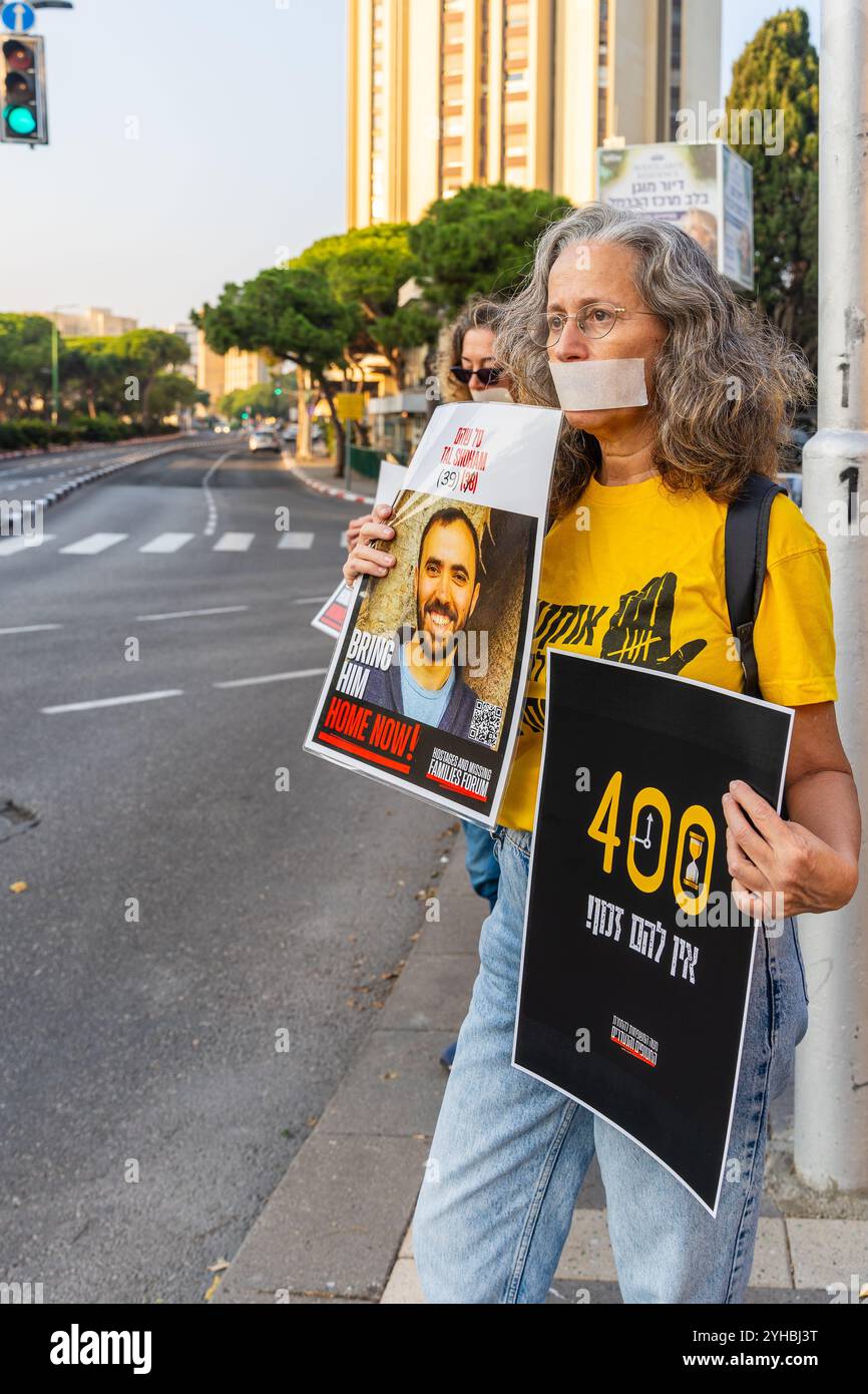 Haifa, Israel - November 09, 2024: People stand with hostage posters ...