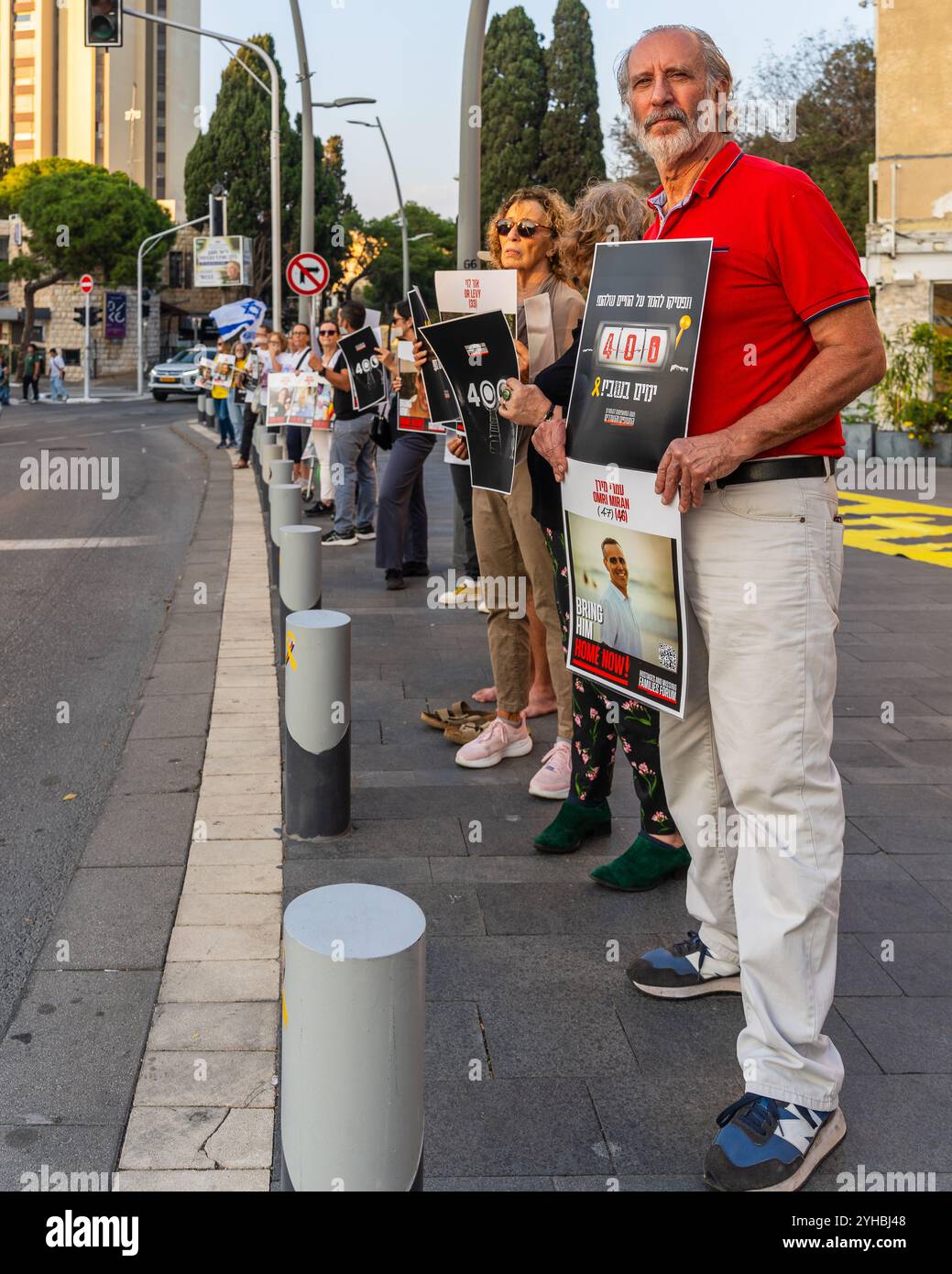 Haifa, Israel - November 09, 2024: People stand with hostage posters ...