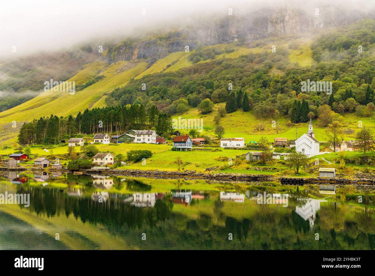 The farming village of Dyrdal with its pretty white church on the shore ...