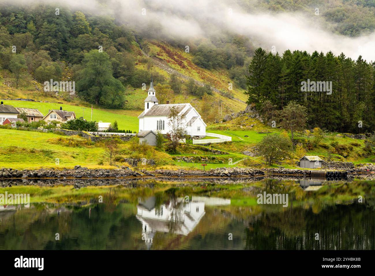 The farming village of Dyrdal with its pretty white church on the shore ...